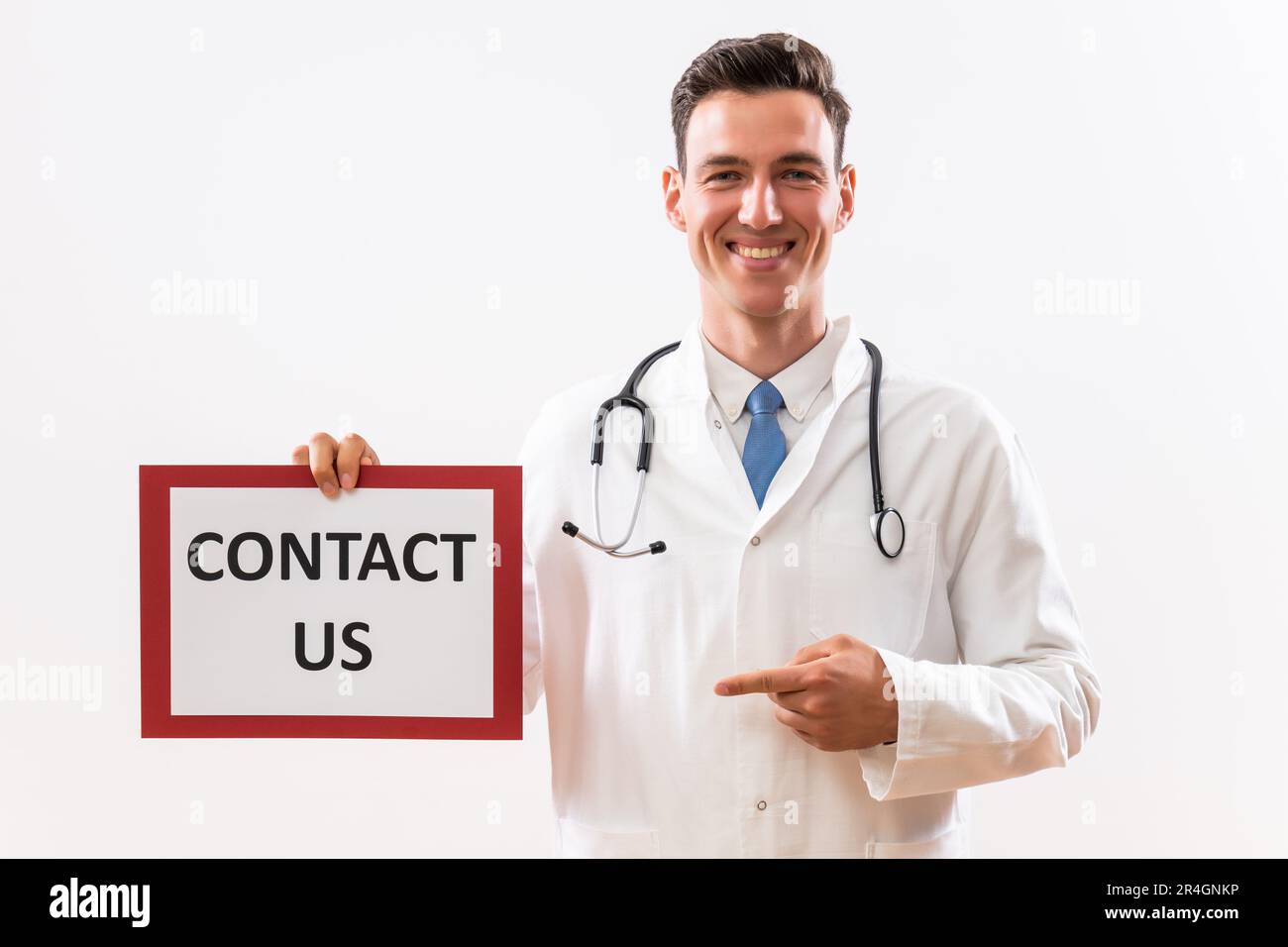 Image of doctor holding a paper with a text contact us Stock Photo - Alamy