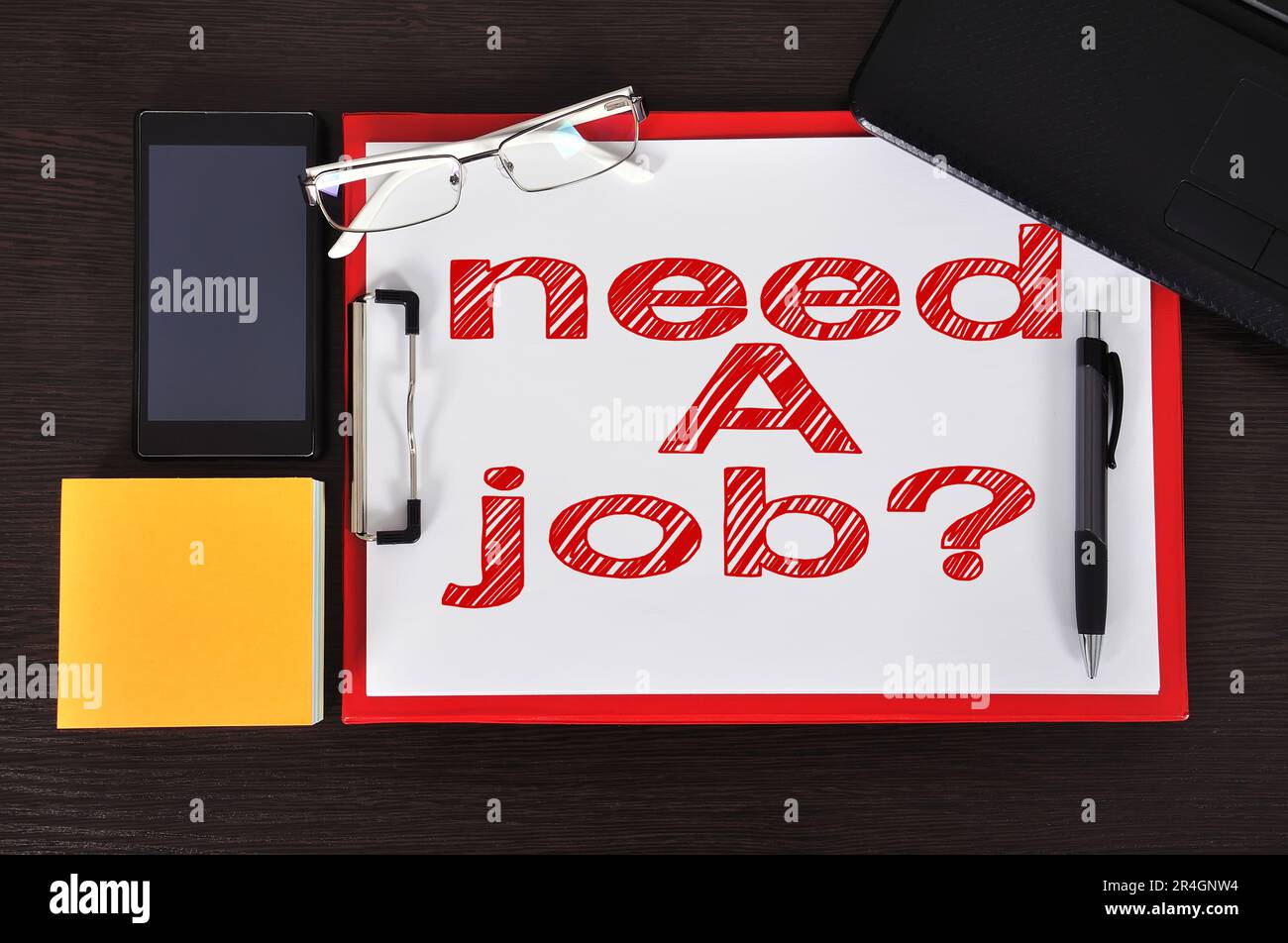 clipboard with need a job on table and business object Stock Photo - Alamy