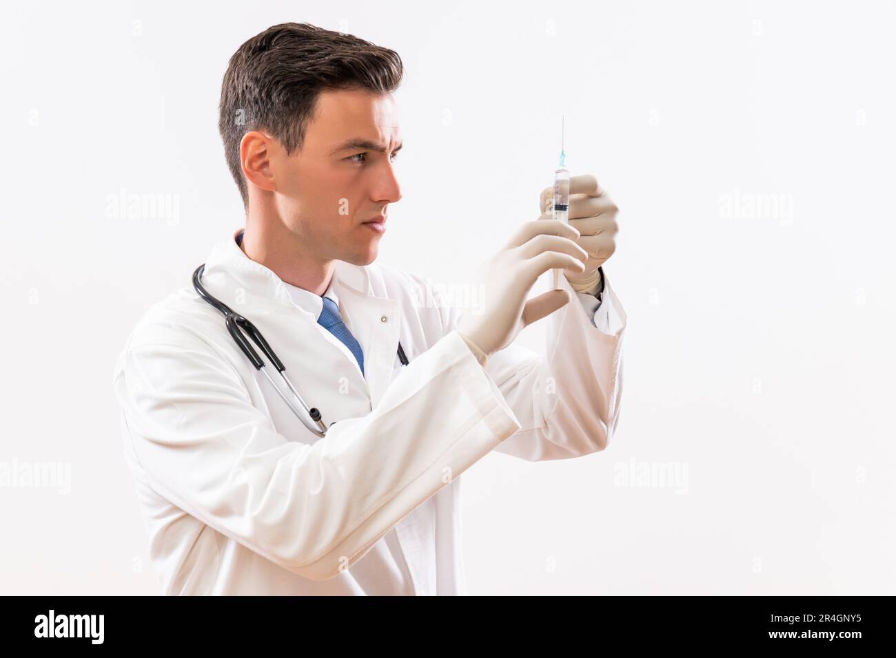 Handsome male doctor holding injection hi-res stock photography and ...
