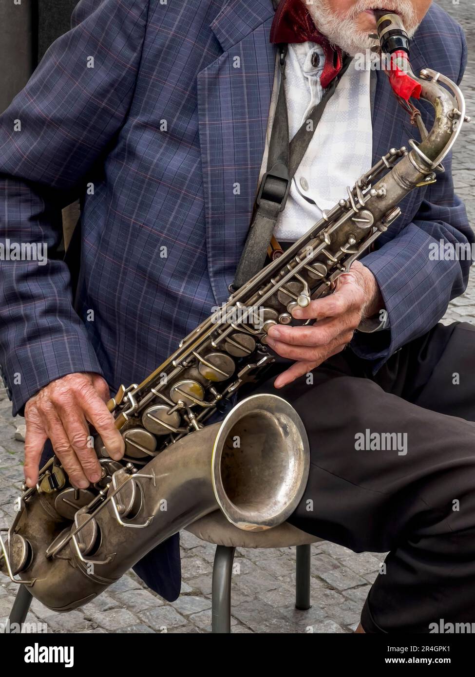 saxophone, closeup wrinkled hands of an old man or male musician ...