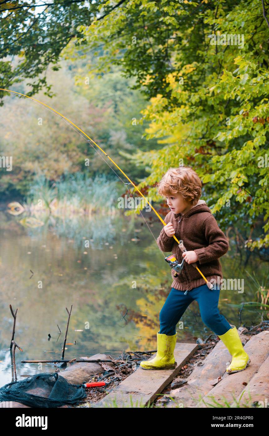 Little boy fishing. Kid pulling rod while fishing on weekend Stock ...