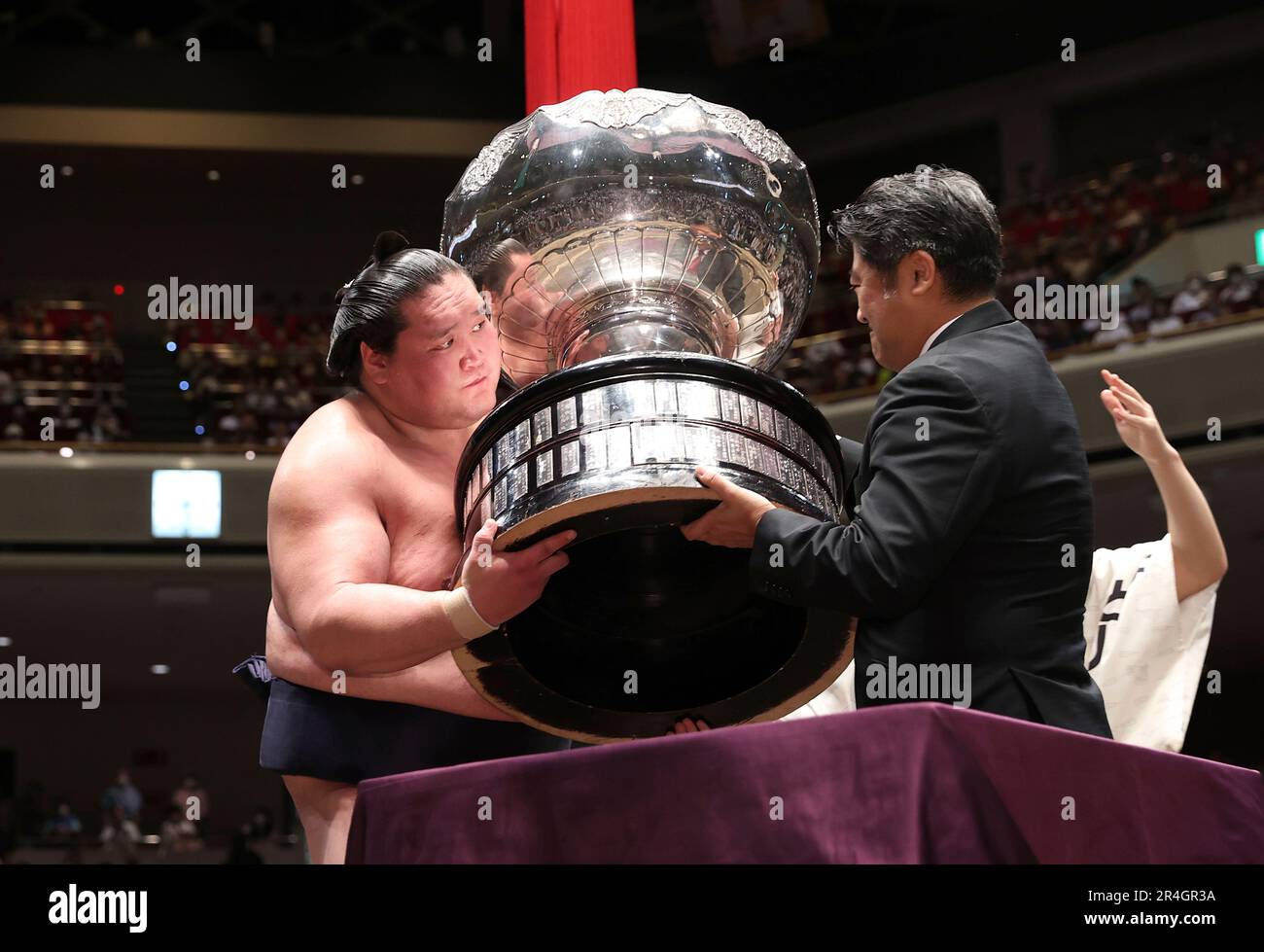 Yokozuna Terunofuji of Mongolia receives a victory trophy after winning ...