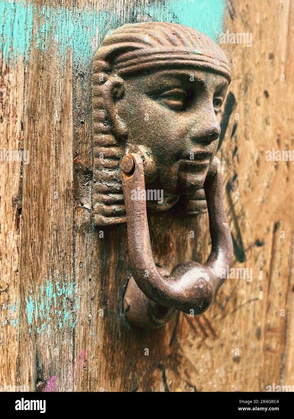 door knock, side view selective focus human face or head shaped knocker ...