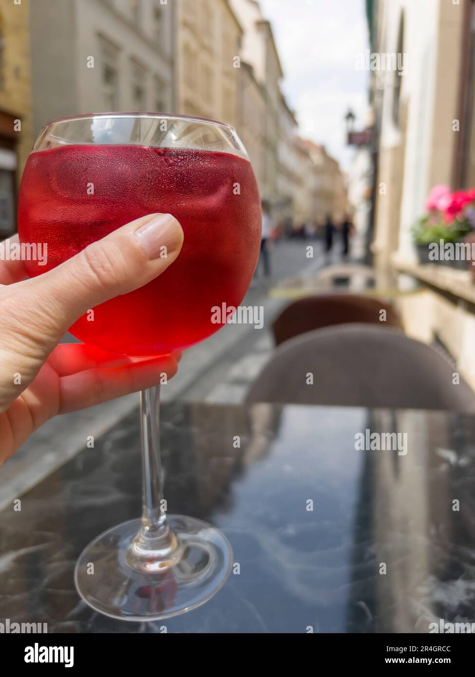 cocktail, hand holding glass of martini fiero cocktail over blurred ...