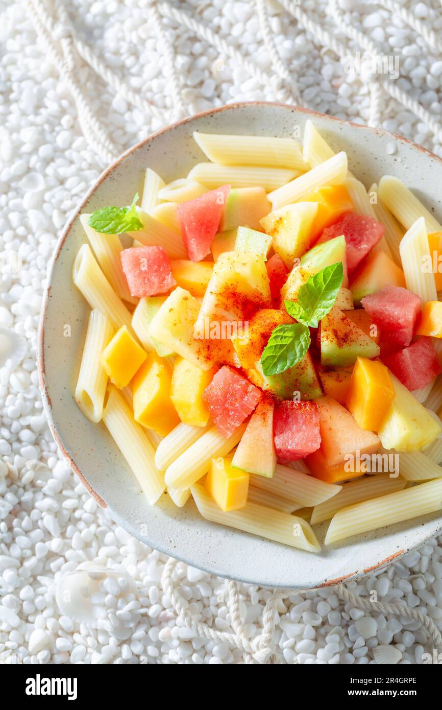 Sweet and homemade penne with mix of colorful fruits. Summer pasta with ...