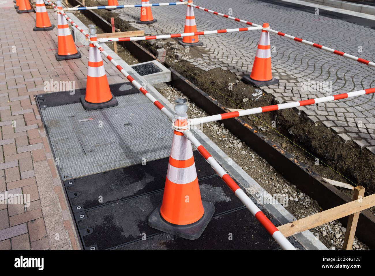 picture of a road construction site with traffic cones and warning tape ...