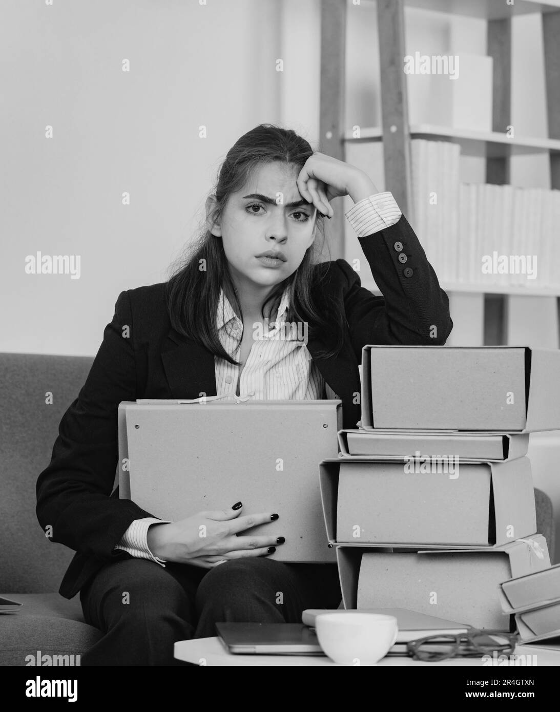 Upset business woman with many folders of documents, unhappy secretary ...