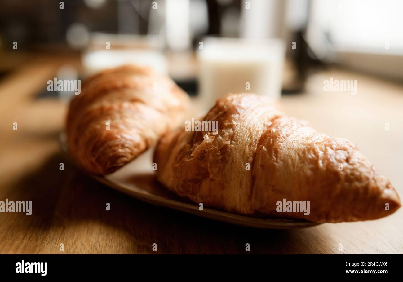 Two fresh croissants on a kitchen table. French breakfast Stock Photo ...