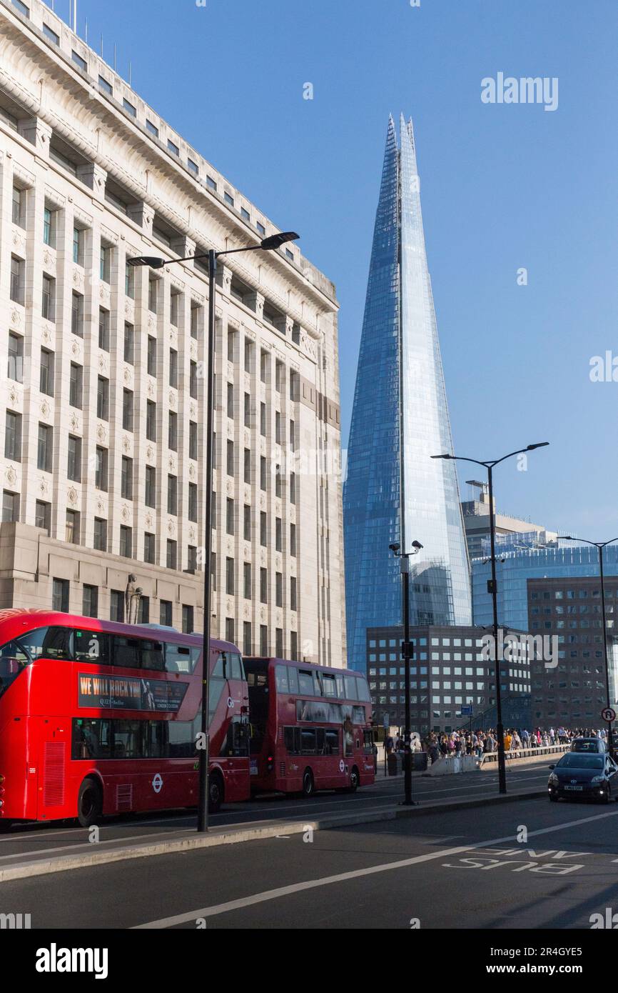 View of the Shard on London Bridge with red London Buses Stock Photo ...