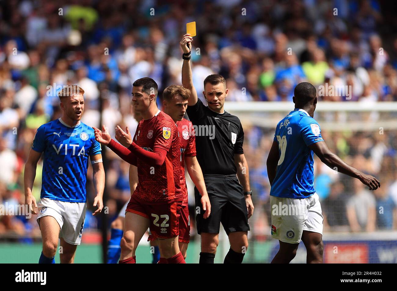 Carlisle United's Jon Mellish is shown a yellow card by referee Tom ...