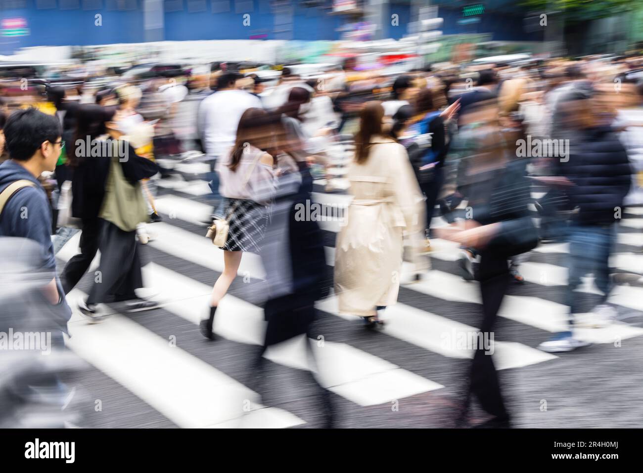 picture with camera made motion blur of a crowd of people crossing the ...