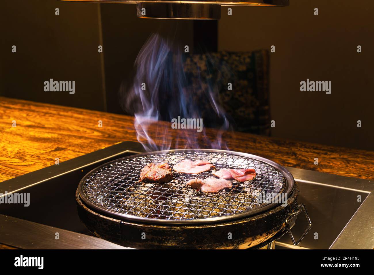 picture of Japanese table barbecue with meat on the roast Stock Photo ...