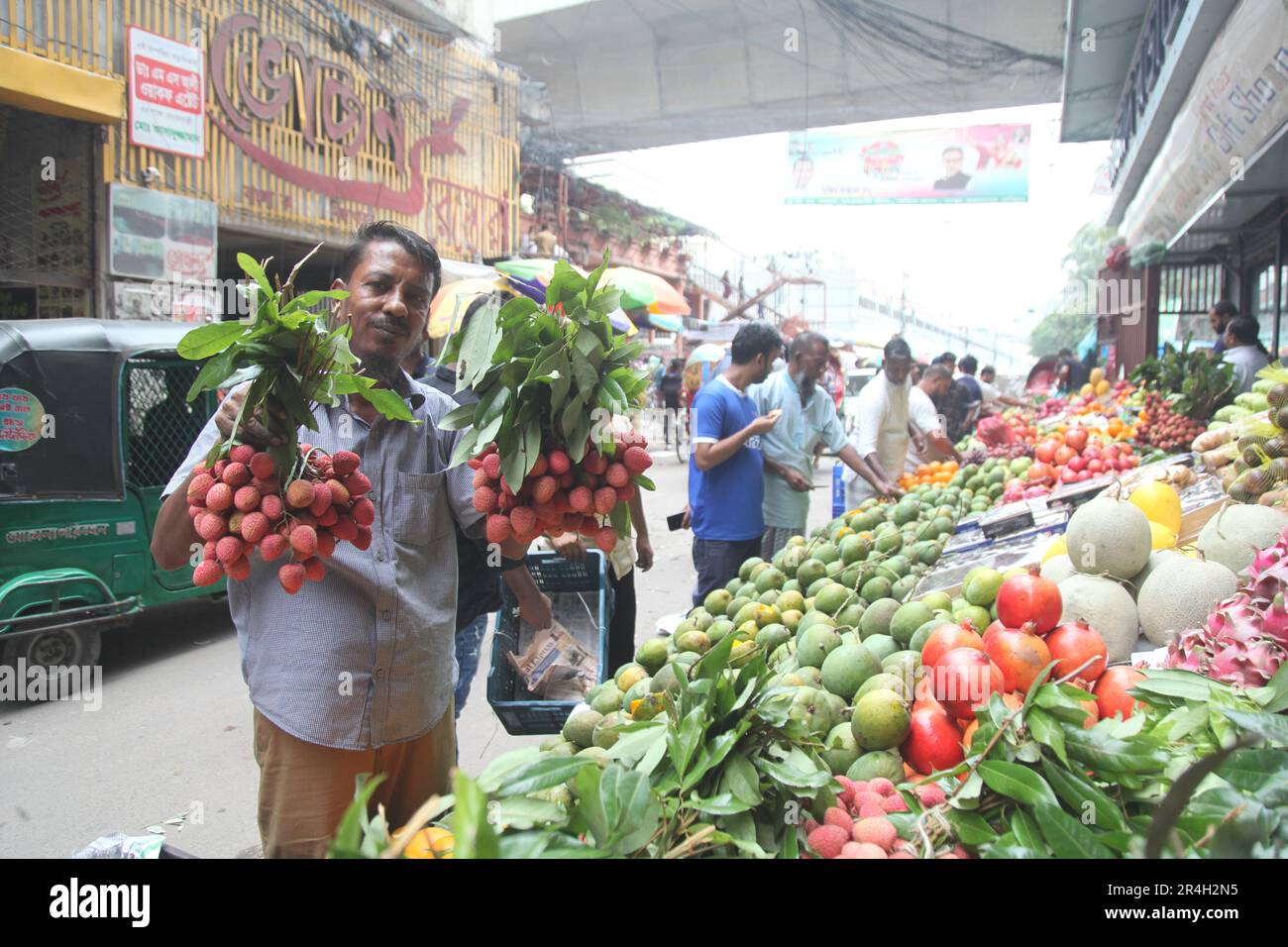 Dhaka, Bangladesh. Bangladeshi vendor sell fruits on a street market in Dhaka, Bangladesh on may ...