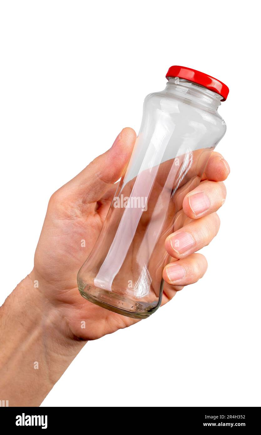 Hand holding empty glass bottle jar closed with red cap isolated on ...