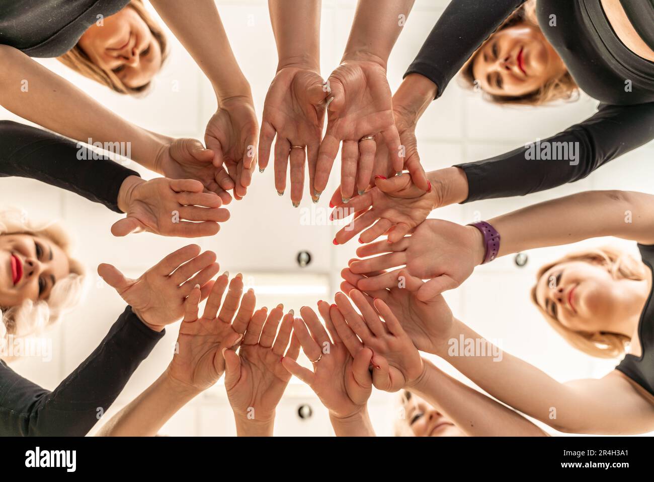 Team of people holding hands. Group of happy young women holding hands ...