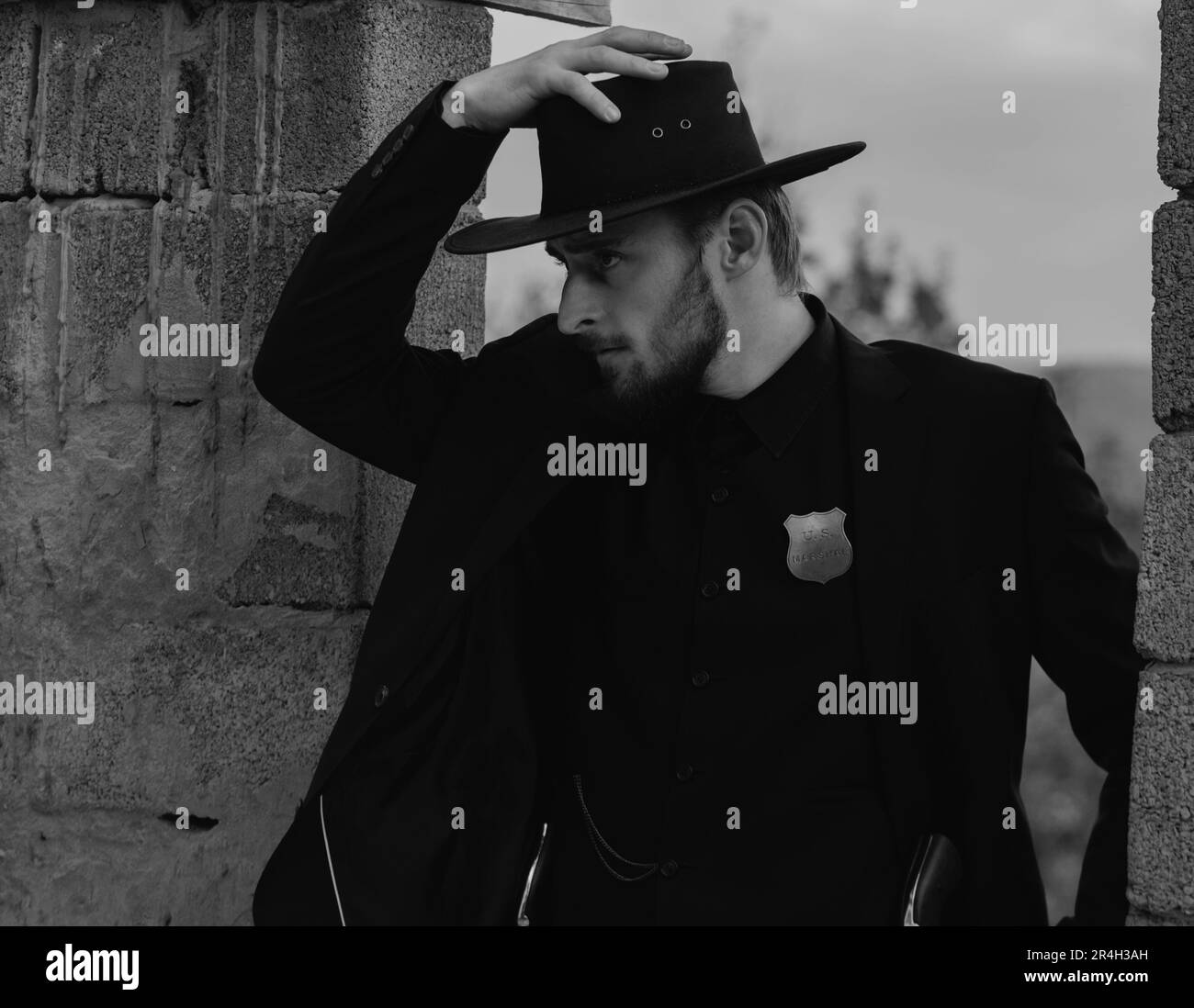 Sheriff or cowboy in black suit and cowboy hat. Man with west vintage ...