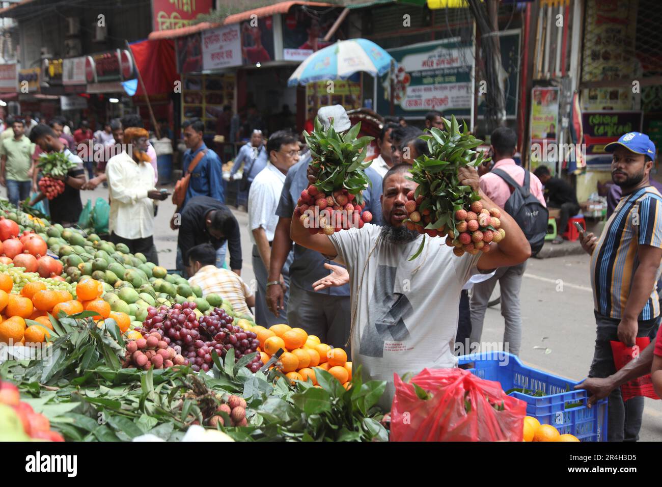Dhaka, Bangladesh. Bangladeshi vendor sell fruits on a street market in Dhaka, Bangladesh on may ...