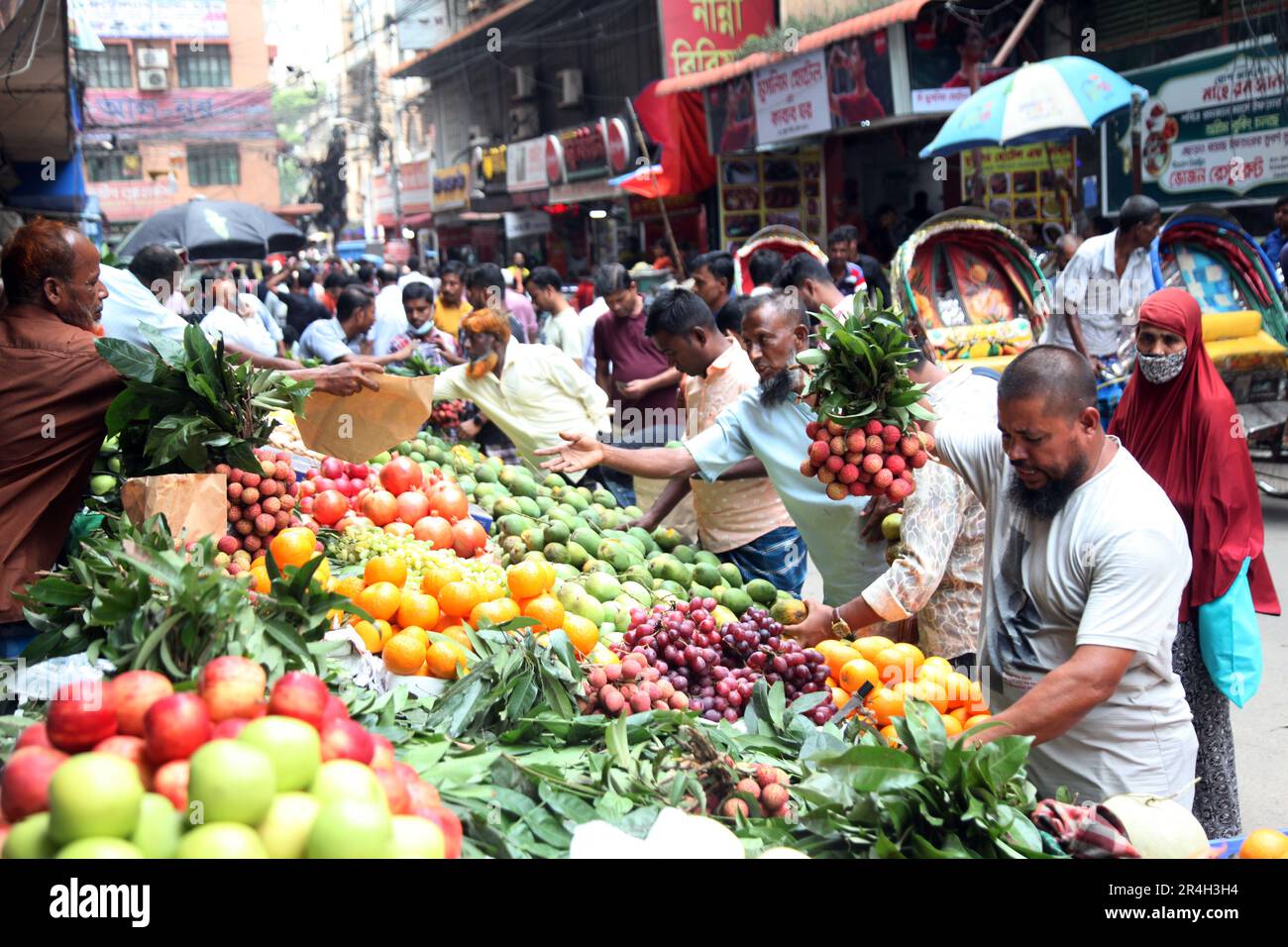 Dhaka, Bangladesh. Bangladeshi vendor sell fruits on a street market in Dhaka, Bangladesh on may ...