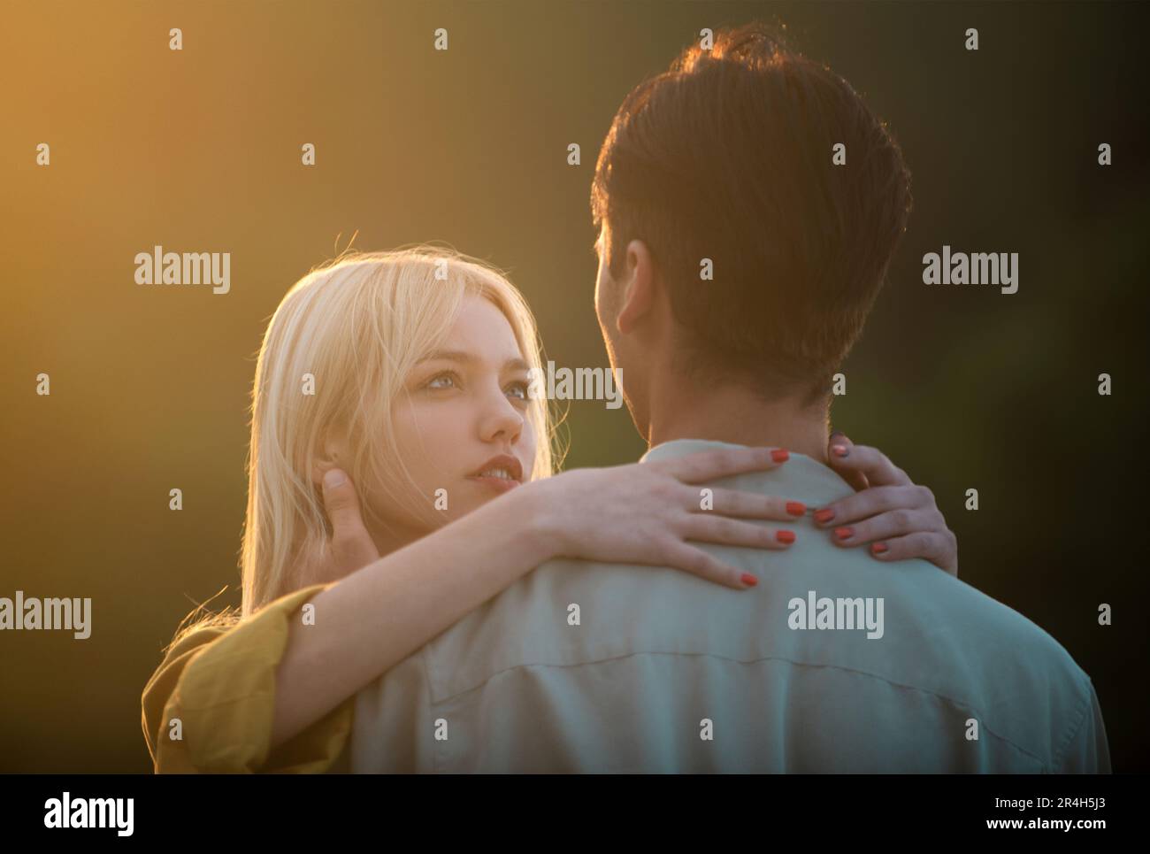 Sensual portrait of young couple in love. Couple lovers hugging and kissing at sunset. Loving ...