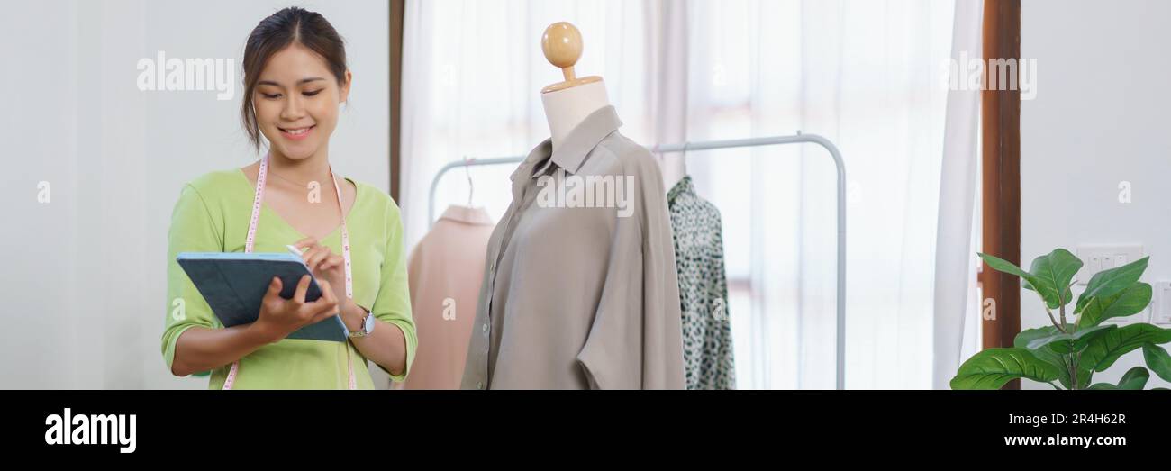 Fashion clothes online concept, Female designer checks detail of ...