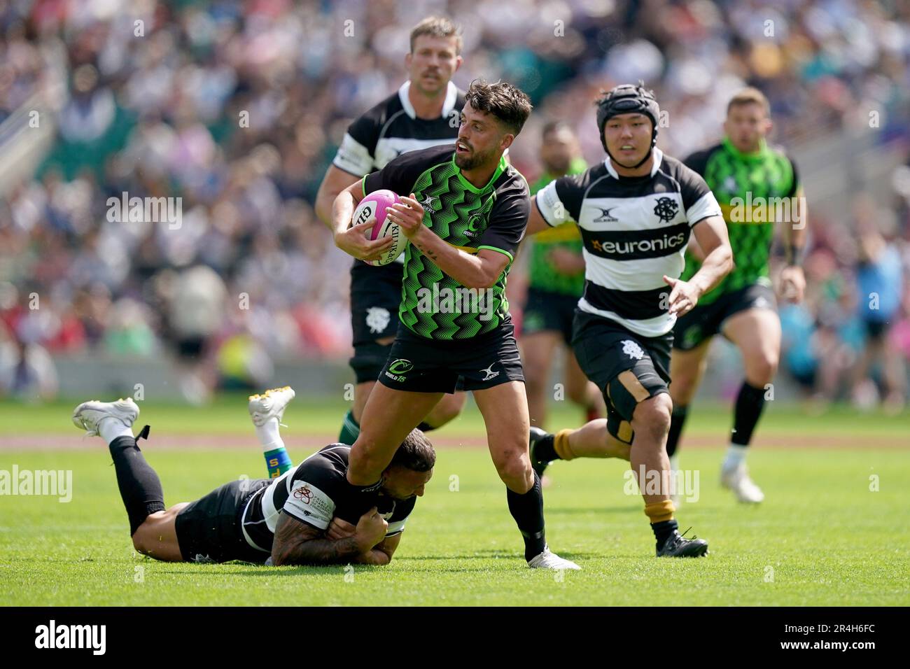 World XV’s Adam Hastings is tackled by Barbarians’ Quade Cooper (left ...