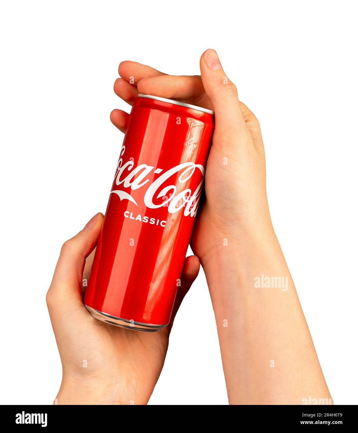 Lodz, Poland May 26 2023 Hand holding Cola drink in red can tin ...