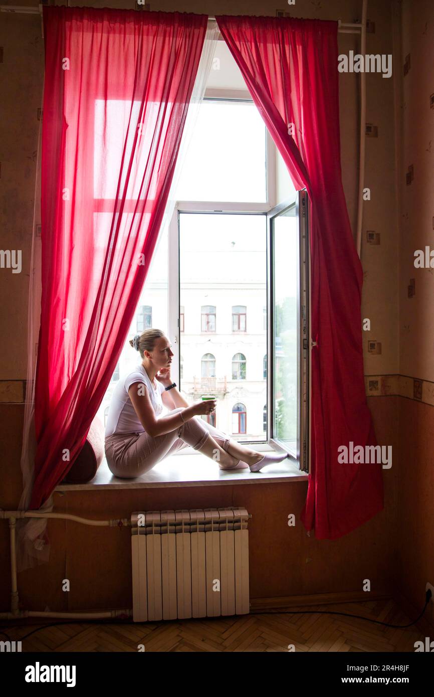 woman standing looking out the full long window Stock Photo - Alamy