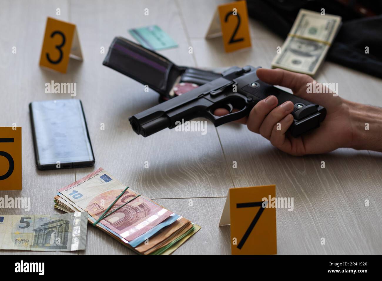 Hand of dead victim surrounded by evidence markers and objects on floor ...