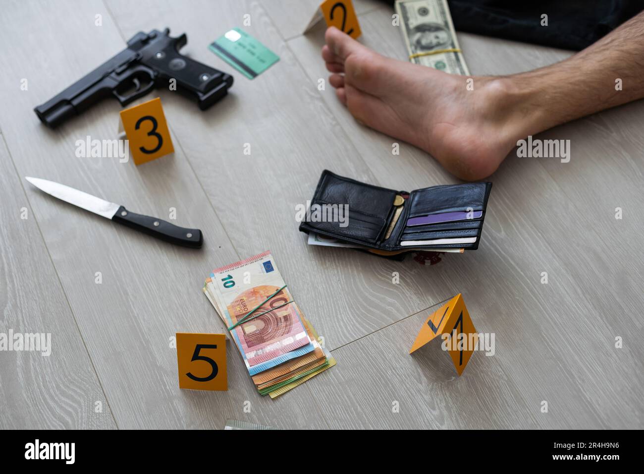 Businessman lying on the concrete floor of a basement, being shot ...