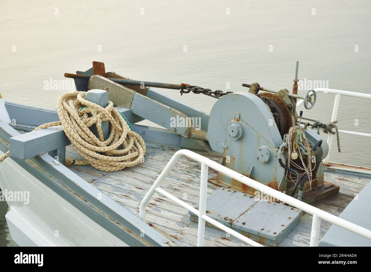 iron boat winch and anchor at ship prow in river on sunset Stock Photo ...
