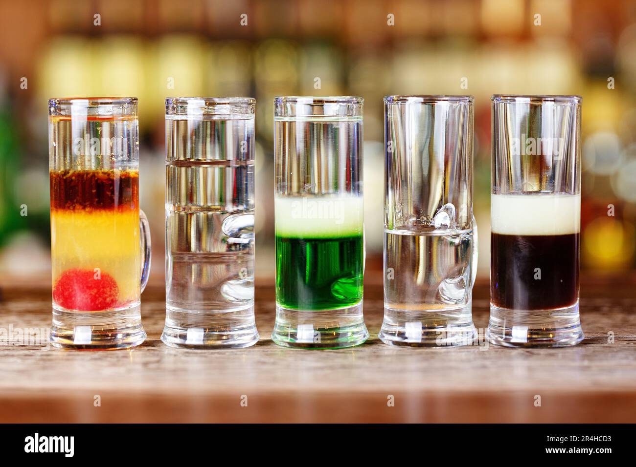 Multi-layered cocktails on the bar in the restaurant, preparation for a ...