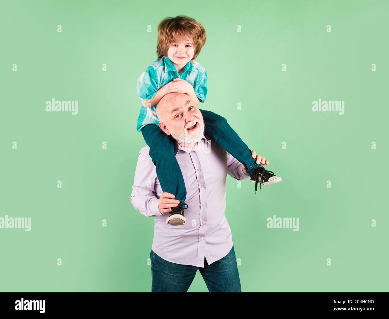 Grandson child and grandfather piggyback ride with funny face isolated ...