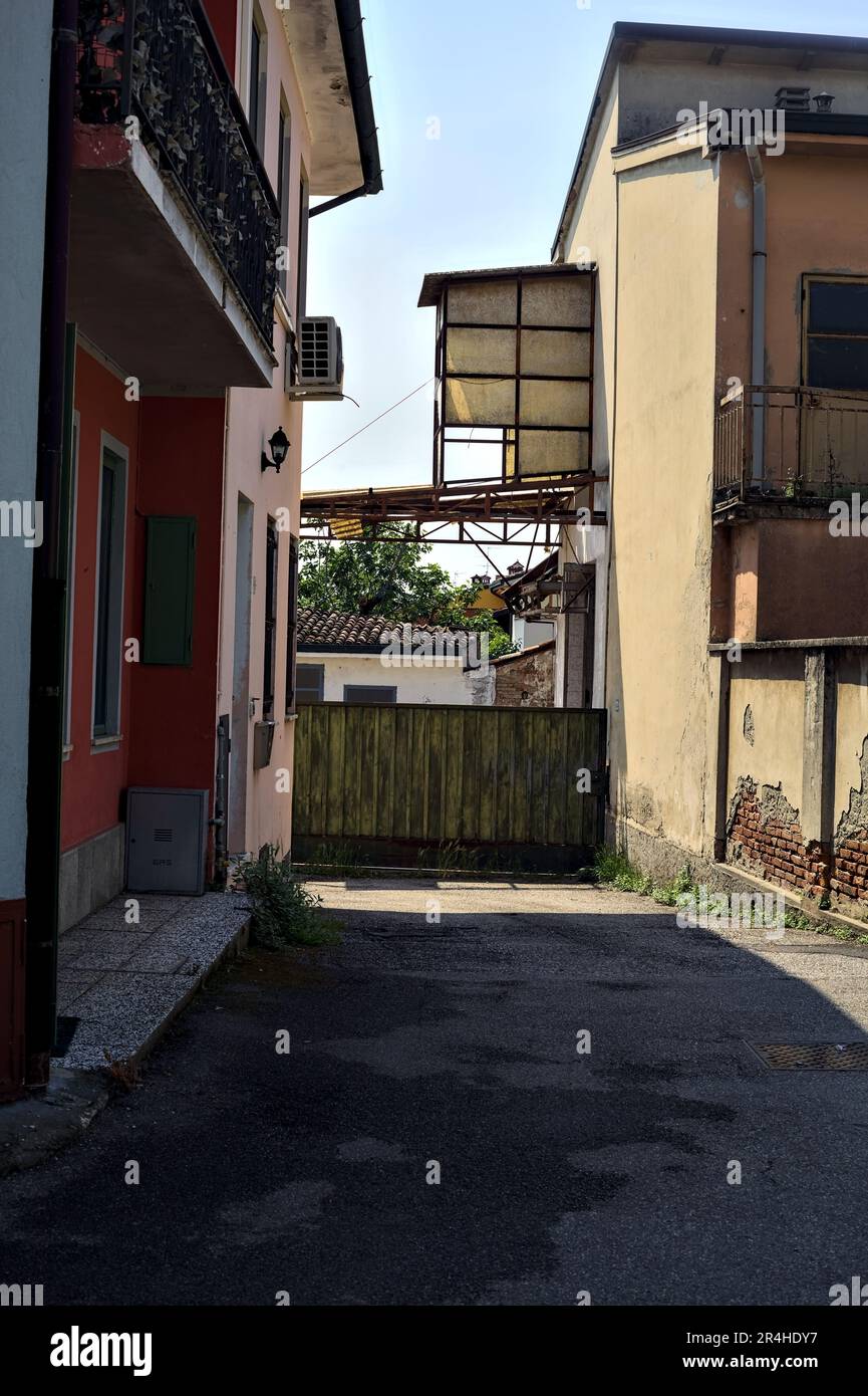 Abandoned warehouse blocked by gates in an alley on a sunny day in the ...