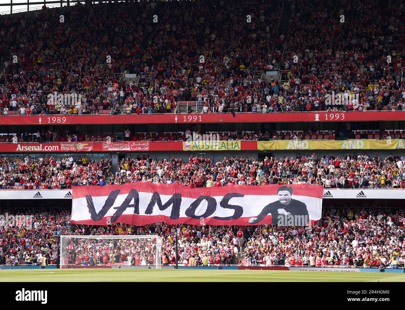 Arsenal fans in the stands wave a banner featuring manager Mikel Arteta ...