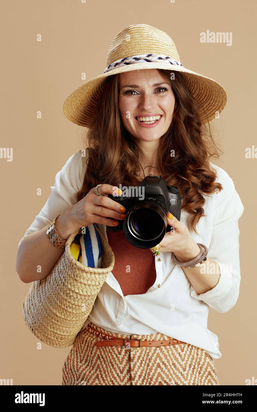 Beach vacation. smiling trendy 40 years old woman in white blouse and ...