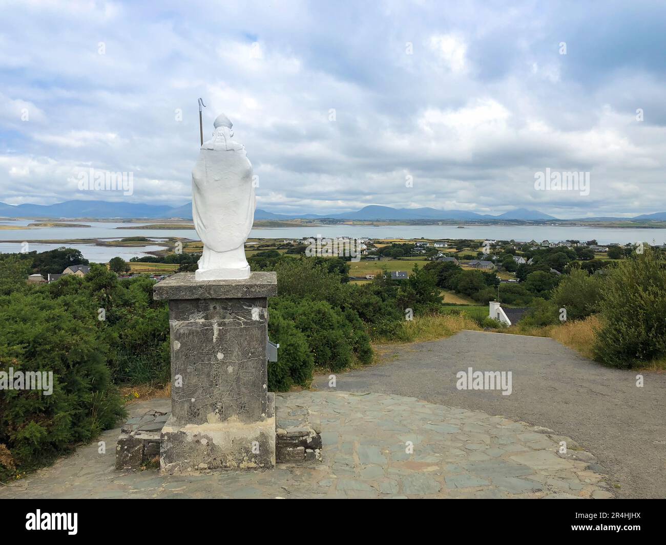 White statue of Saint Patrick at the start of foot path to the peak of ...