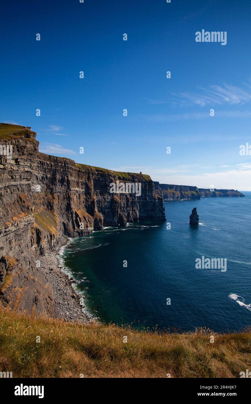 On the very edge of the Cliffs of Moher. The sea cliffs located at the ...