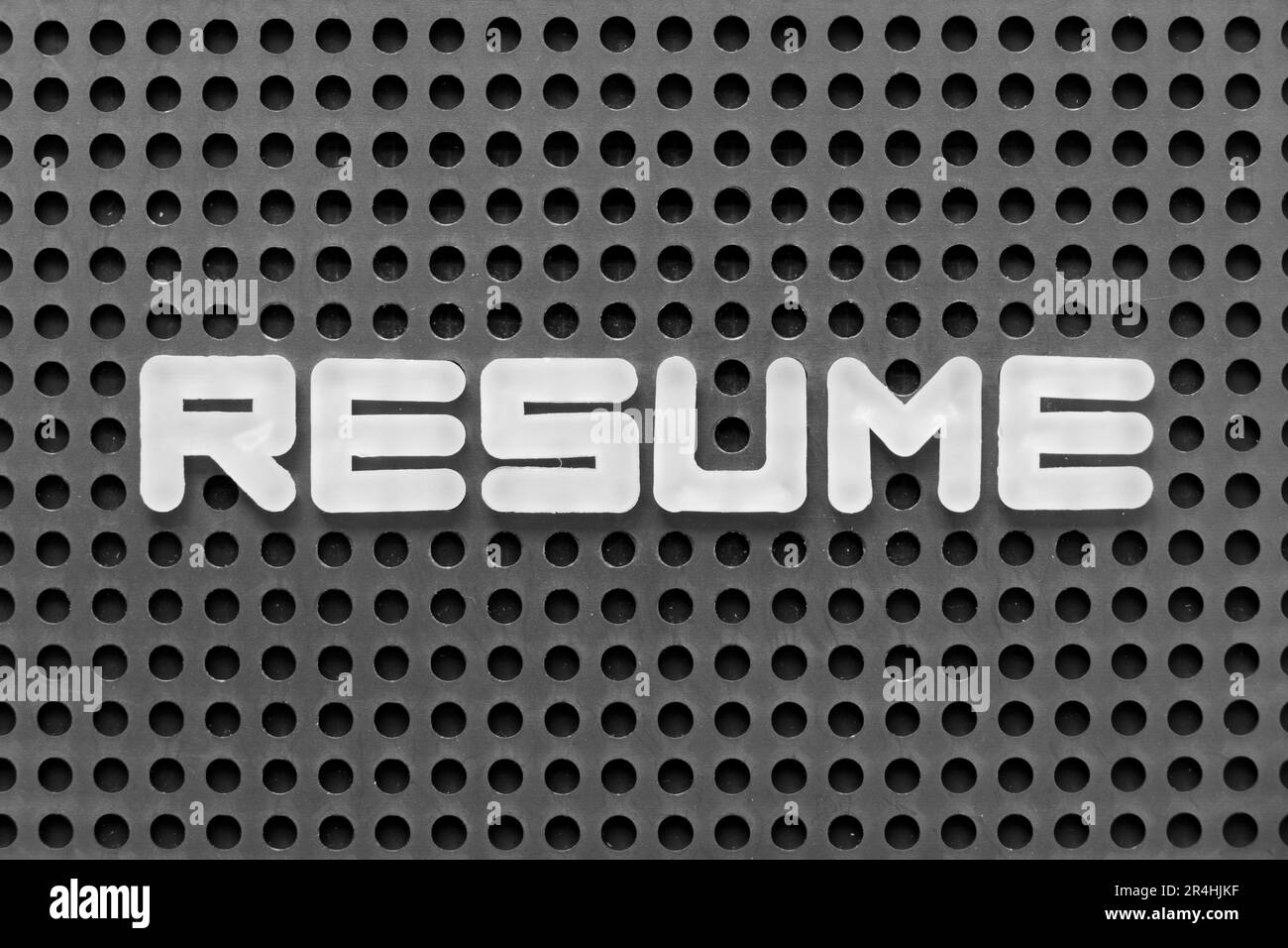 White alphabet letter in word resume on black pegboard background Stock ...