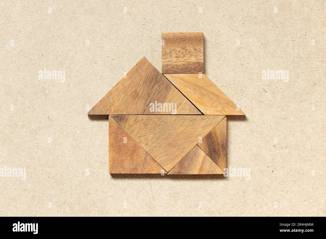 Wooden tangram puzzle in home shape for dream home or happy life ...