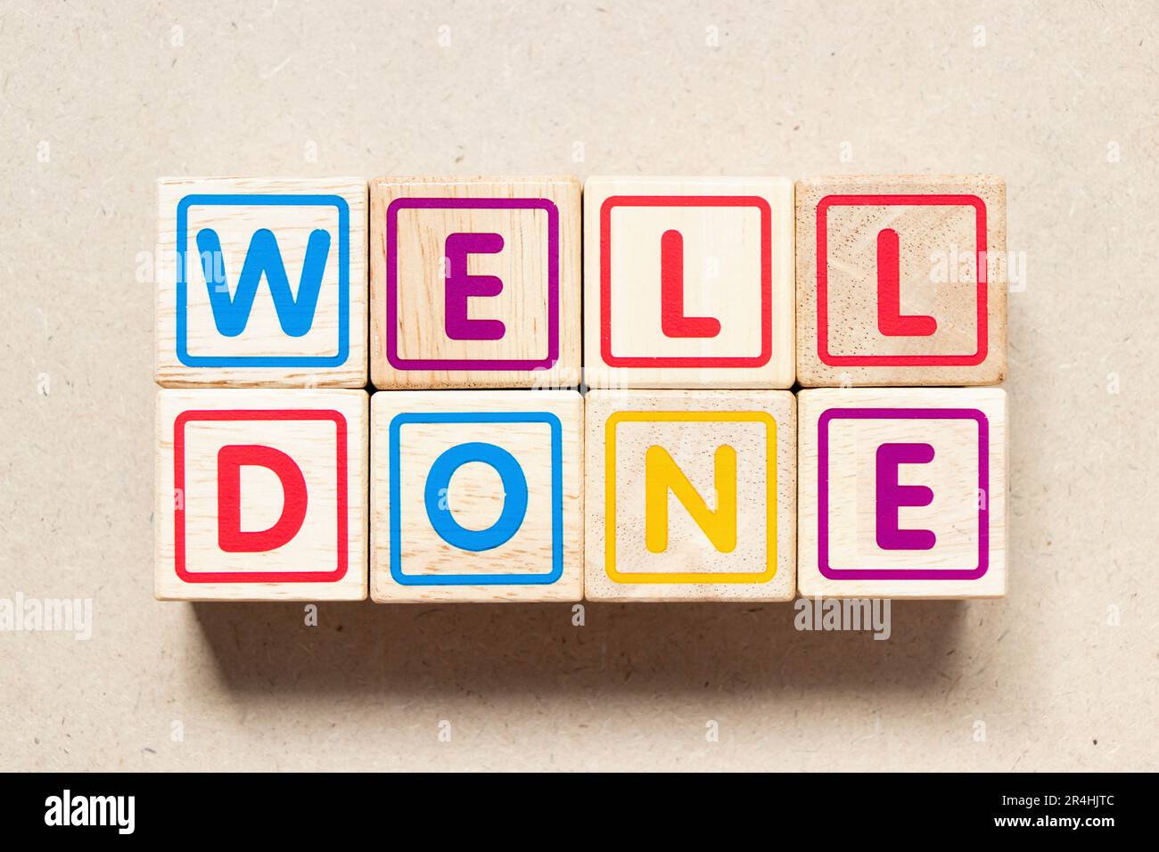 Color letter block in word well done on wood background Stock Photo - Alamy
