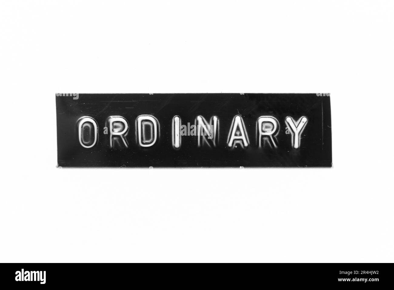 Black color banner that have embossed letter with word ordinary on ...