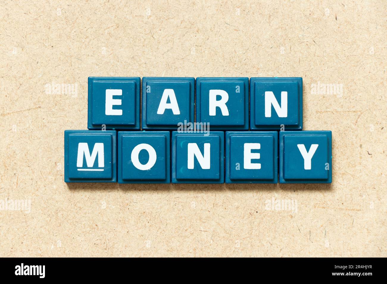 Tile alphabet letter in word earn money on wood background Stock Photo ...