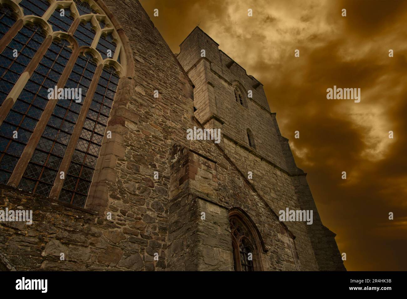 Presteigne church window, tower and yew tree in Powys, Wales. With ...