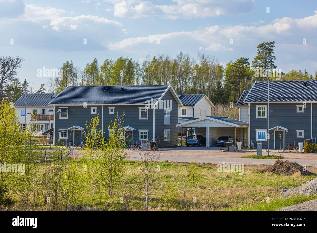Beautiful view of modern European suburb with wooden gray villas and ...
