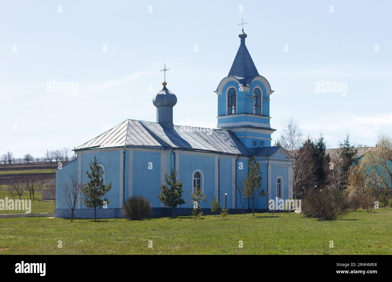 Ancient church of blue color in village on sky background Stock Photo ...