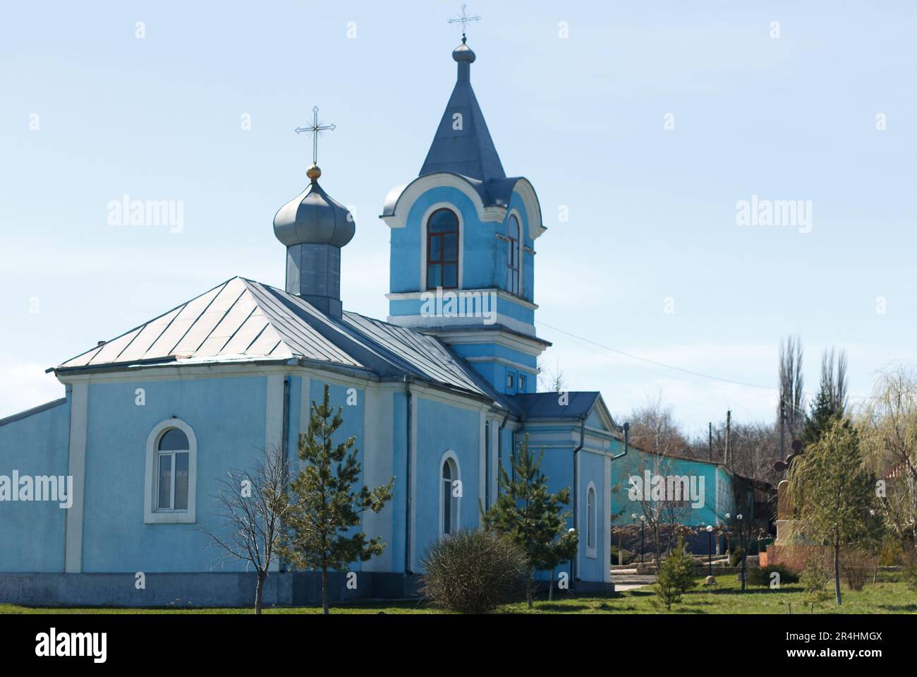 Ancient church of blue color close up in village on sky background ...