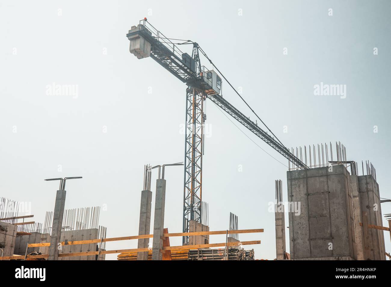 Construction site, crane rising above the building under construction ...