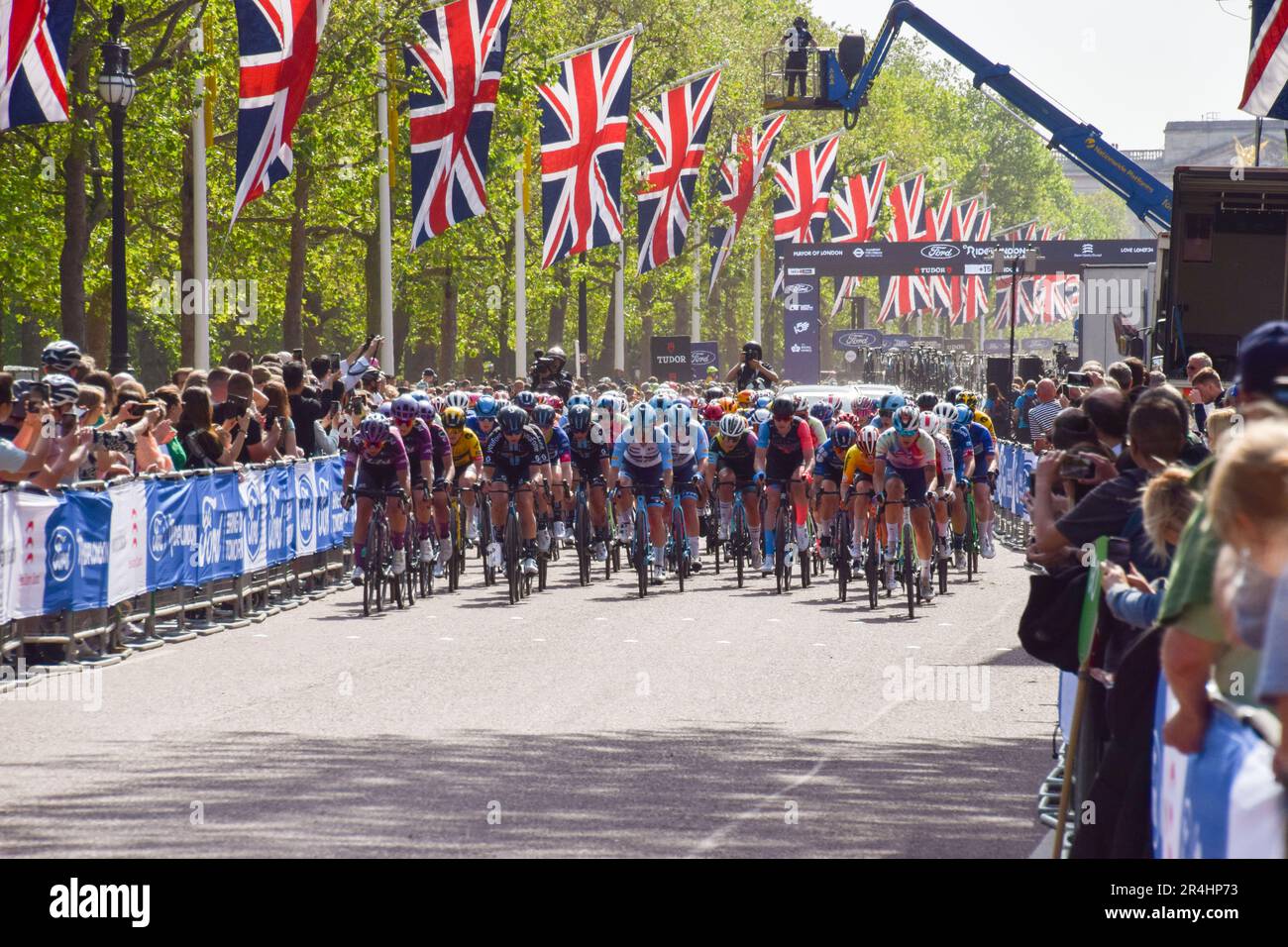 London, England, UK. 28th May, 2023. Cyclists pass through The Mall ...