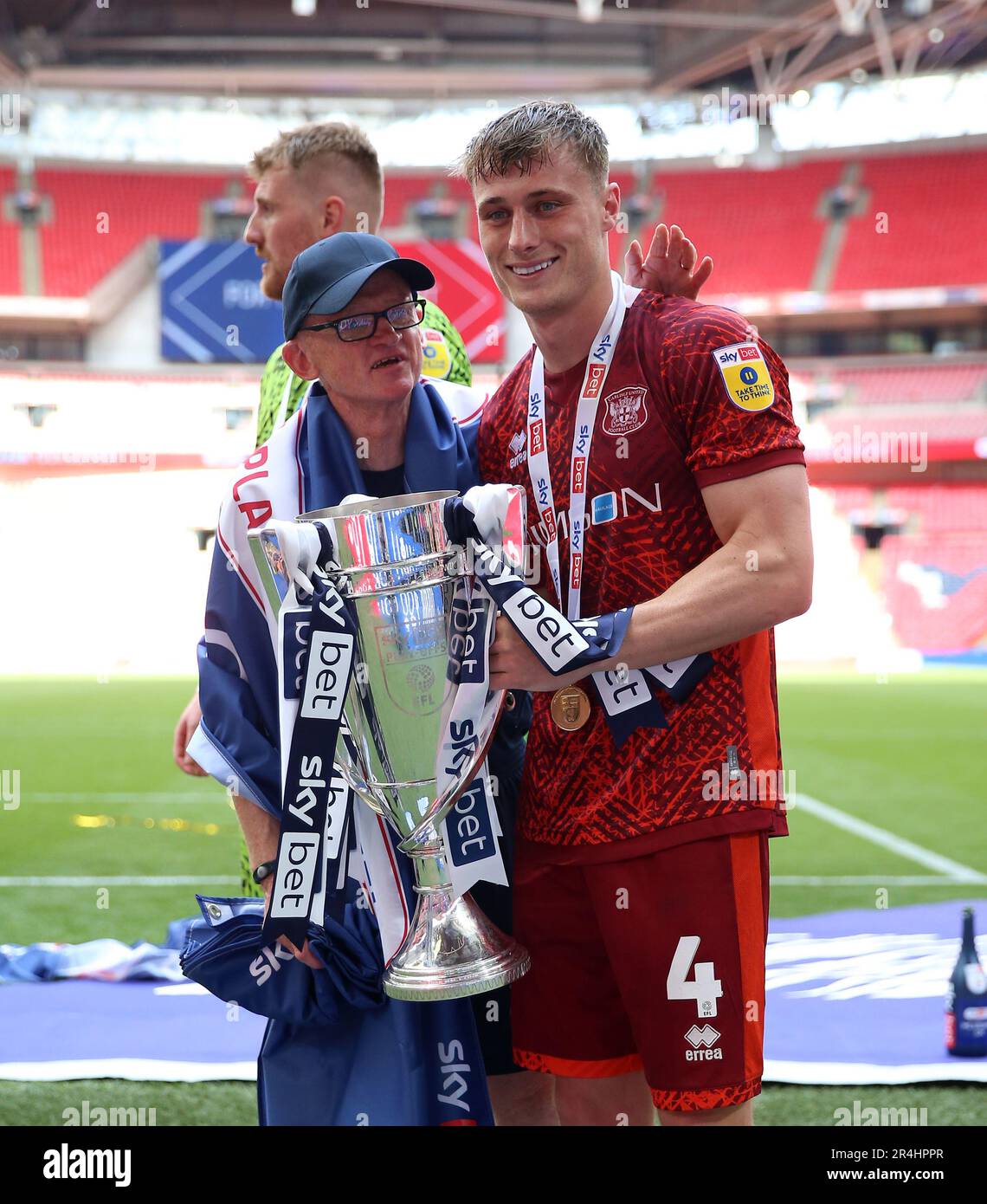 Carlisle United's Owen Moxon (right) celebrates with the trophy after ...
