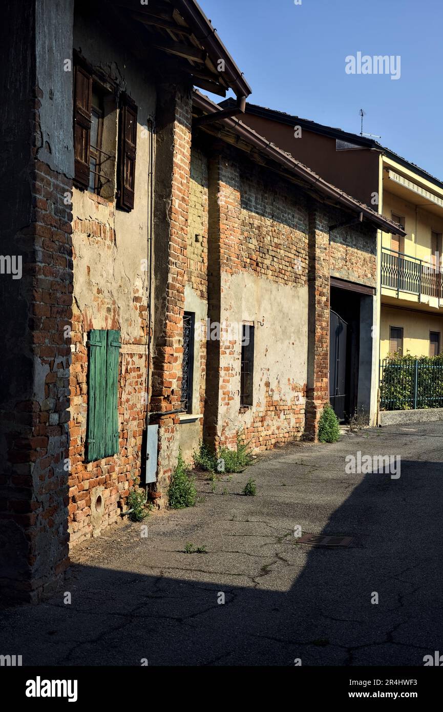Street in a village with old brick houses on a sunny day in the italian ...